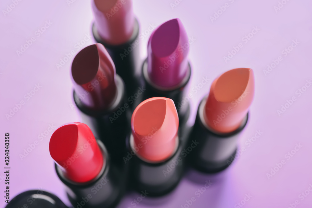 Lipsticks of different shades on color background, closeup Stock Photo ...