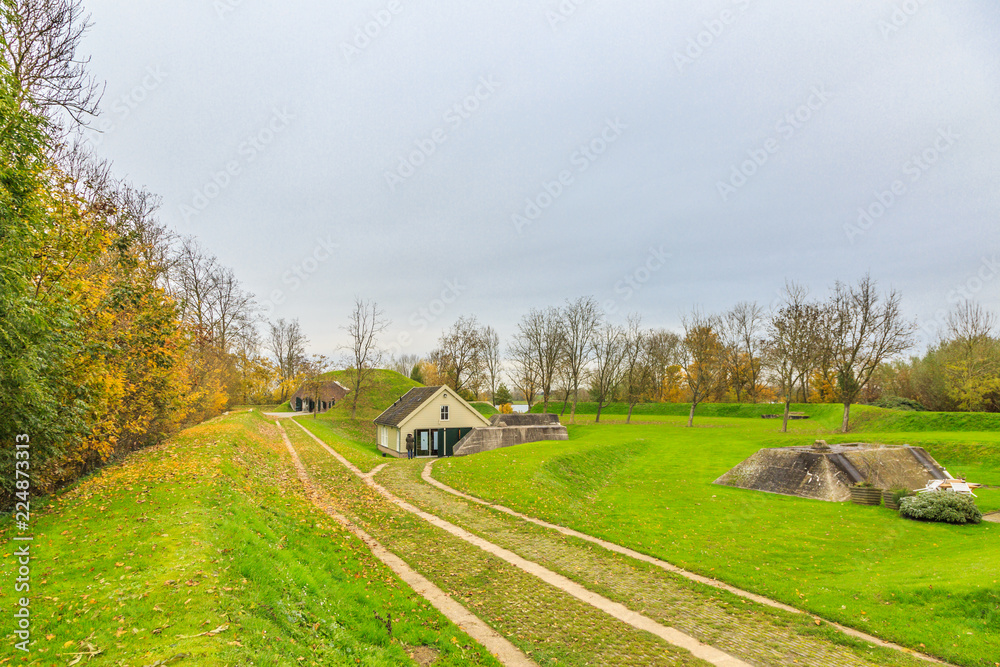 Earthen fortifications with concrete bunkers and wooden storage shed in ...