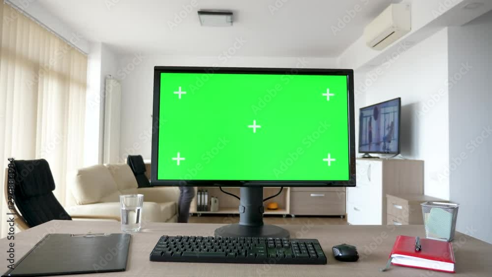 Personal PC computer with big green screen chroma mock up on the table ...