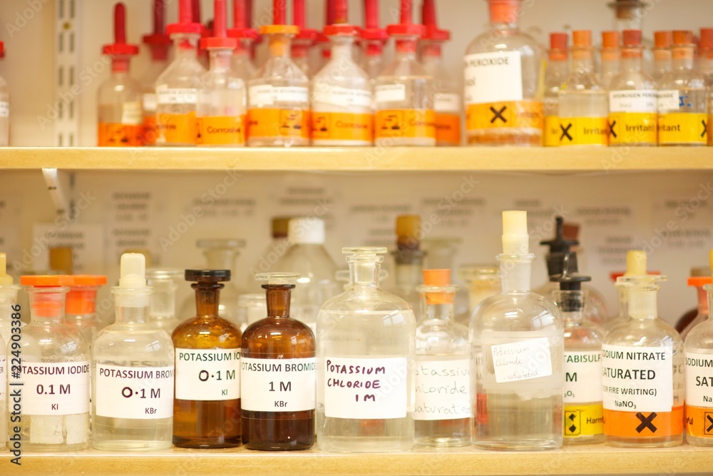 Bottles of chemcicals on shelves in a Science laboratory including ...