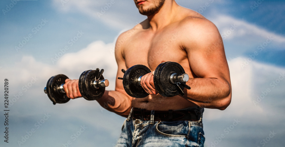 Dumbbell. Strong bodybuilder, perfect deltoid muscles, shoulders ...