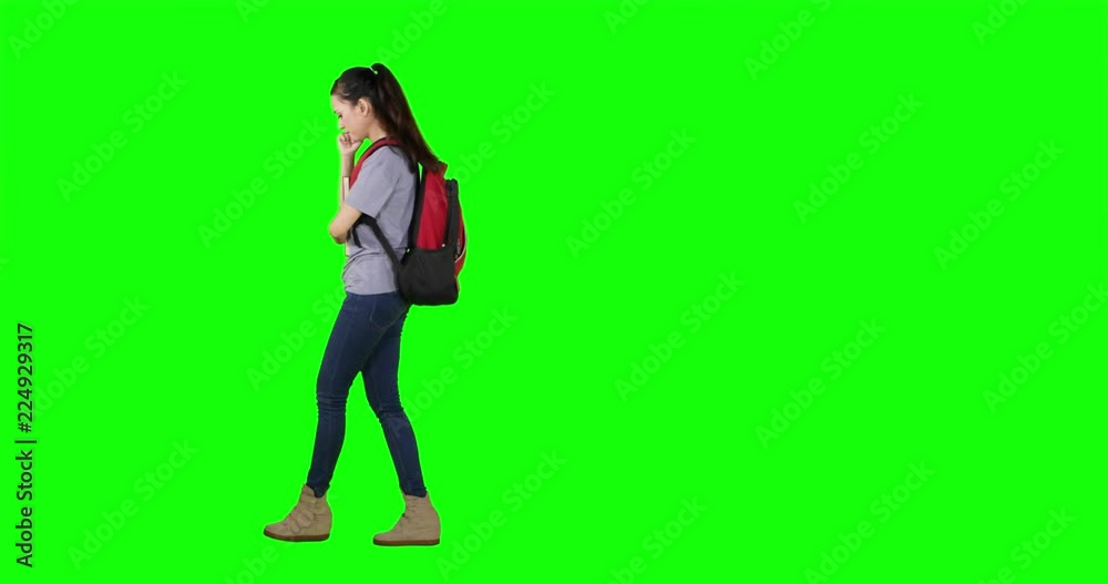 Full length of female high school student walking back and forth in the studio while thinking ...