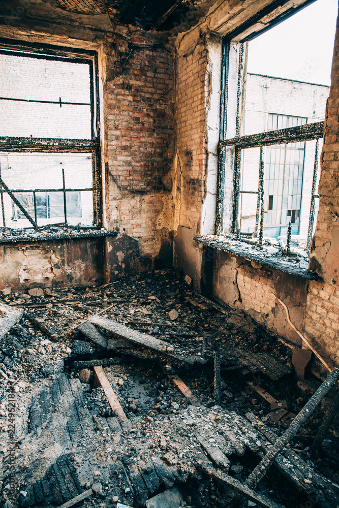 Burnt room interior with walls, furniture and floor in ash and coal ...