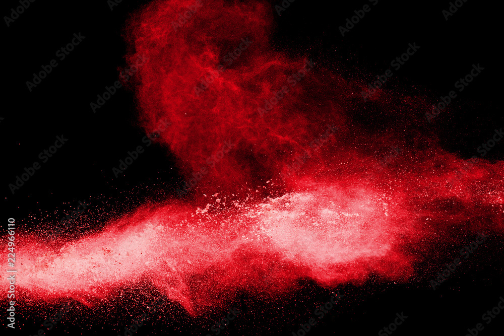 Red color powder explosion on black background.Freeze motion of red ...