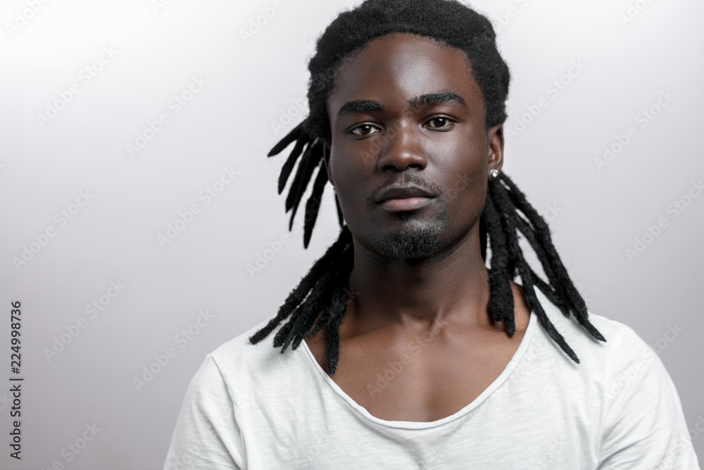 African American male with dreadlocks on white background looking at ...