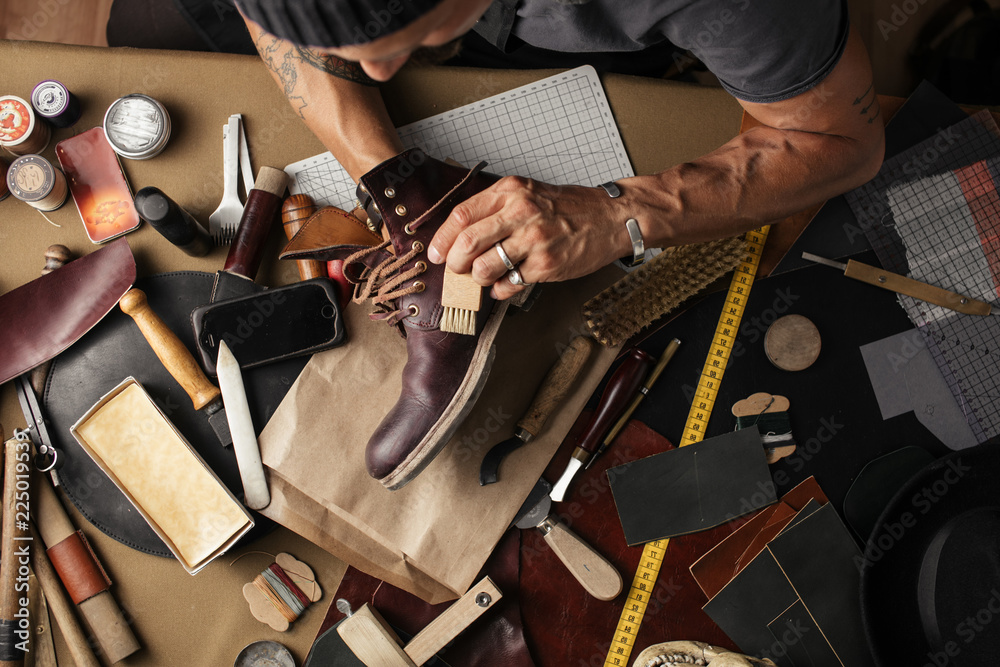 Enjoying process of creation custom made shoes. Workplace of shoe ...