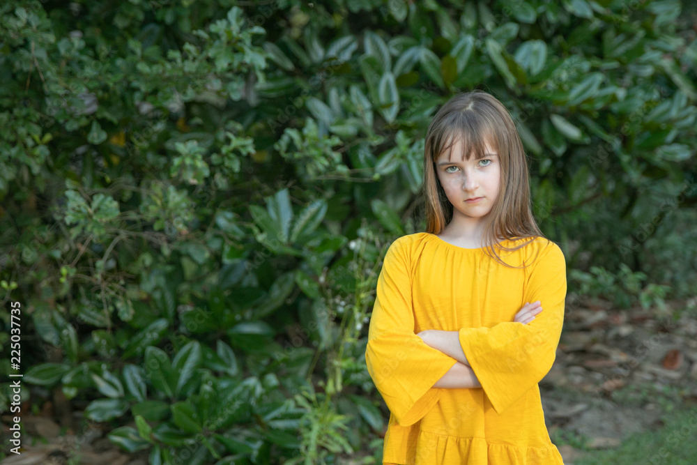 Tween Girl in Yellow Gold Outside in Greenery with Attitude Stock Photo ...