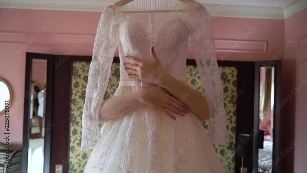 Bride morning preparation. Beautiful bride in white wedding negligee ...