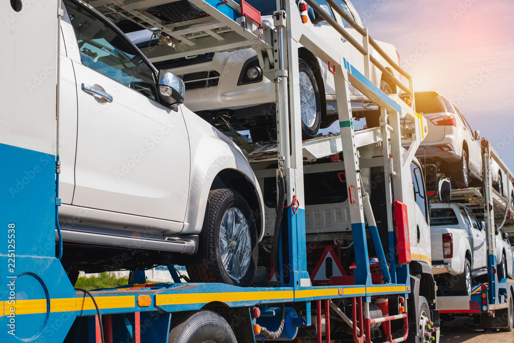 Logistics, transportation of new cars on a two-level semi-trailer truck ...