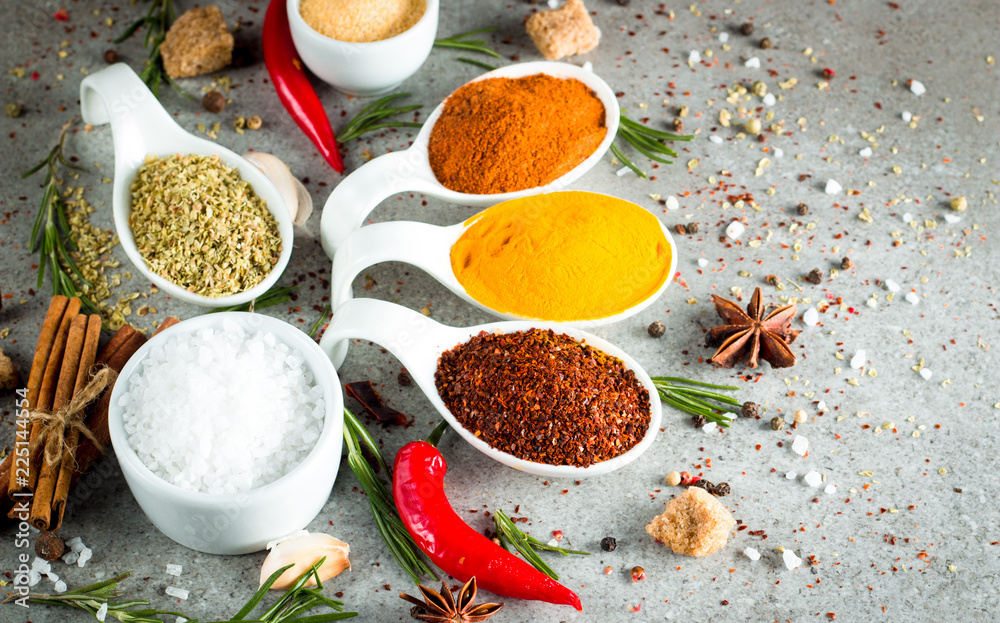 Spices in Wooden spoon. Curry, Saffron, turmeric, rosemary, cinnamon ...