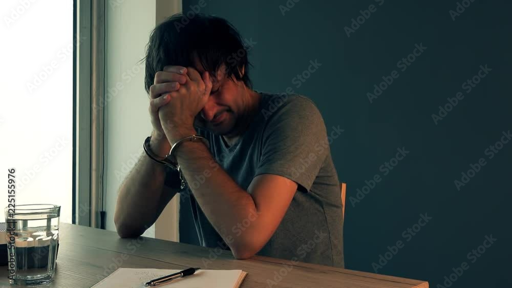 Desperate criminal in interrogation room during police interview with ...