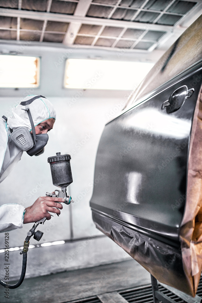 Painting the car in black color in the paint chamber on the service ...