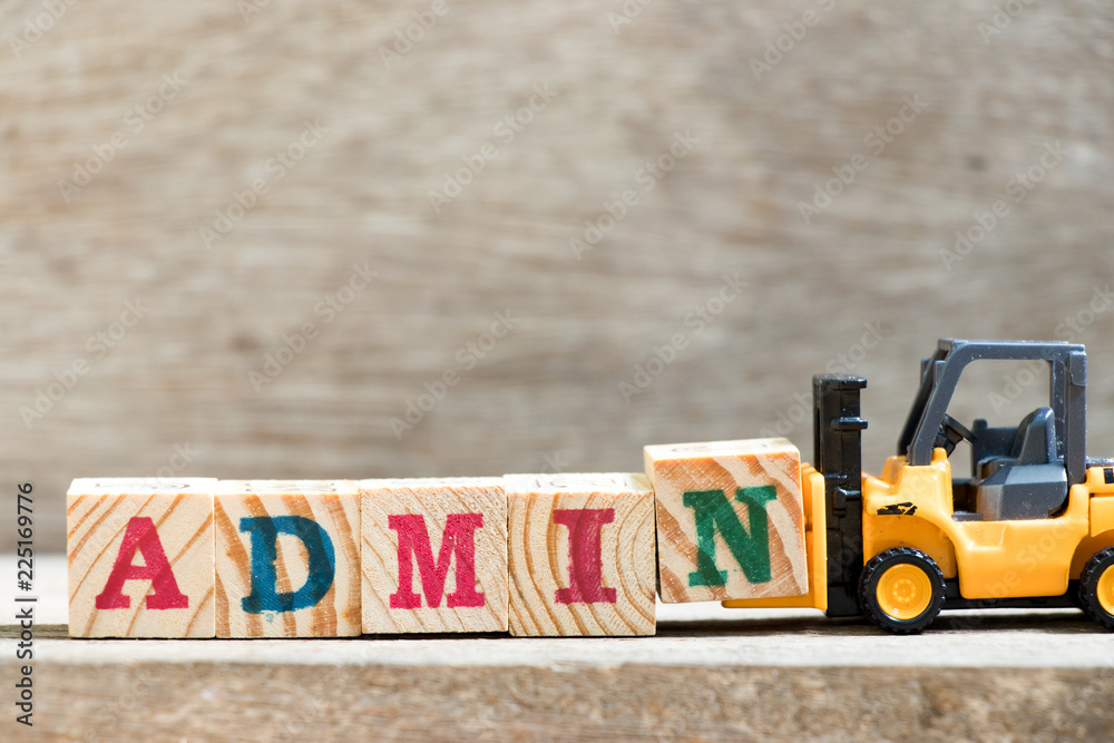 Toy forklift hold letter block N in word admin on wood background Stock ...