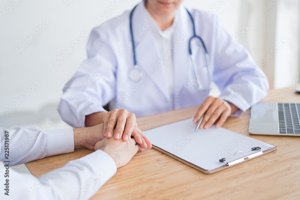 Close up of doctor touching patient hand for encouragement and empathy ...