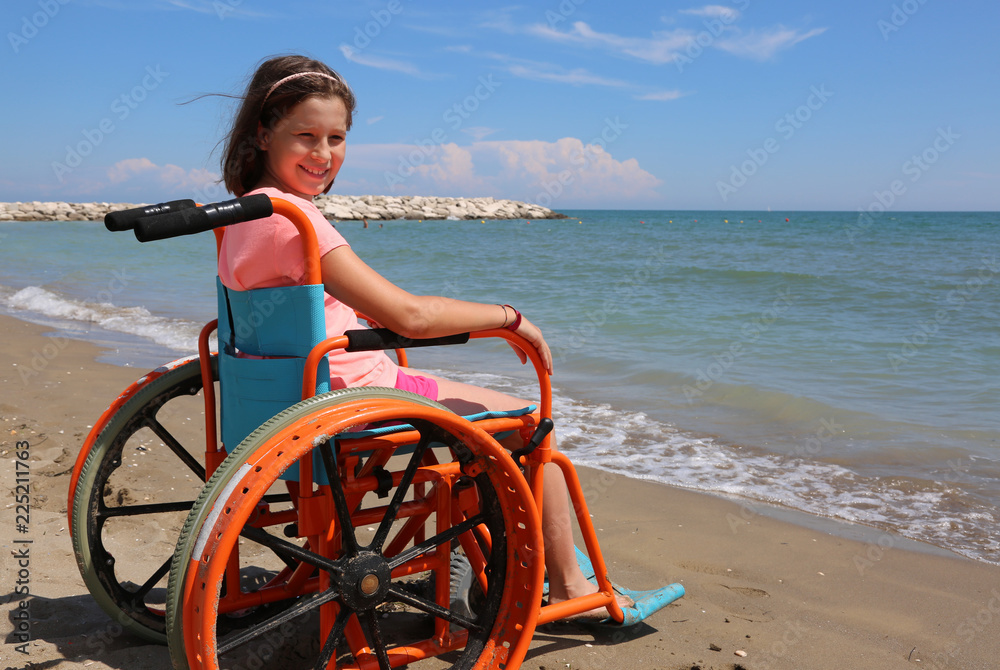 little girl on the wheelchair with special wheels Stock Photo | Adobe Stock