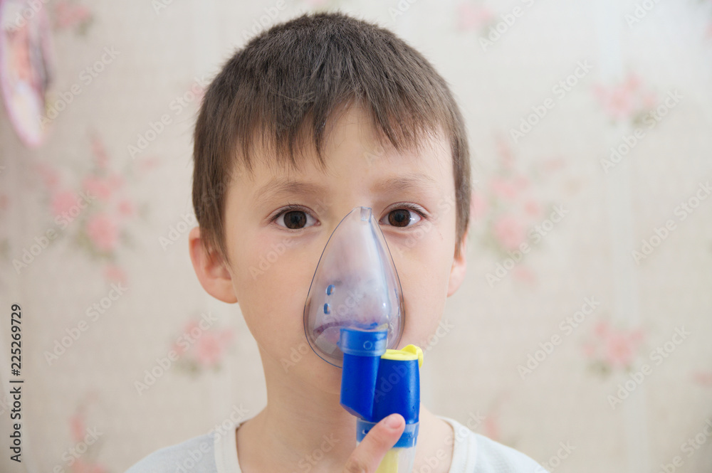 sick boy in nebulizer mask making inhalation, respiratory procedure by ...