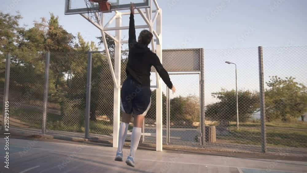 Low angle footage of a proffesional female basketball player in action ...