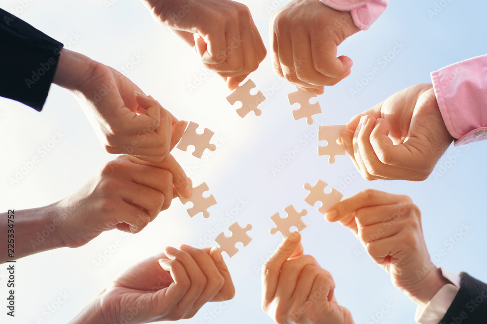 team hand power full placing the jigsaw puzzle piece for connect ...