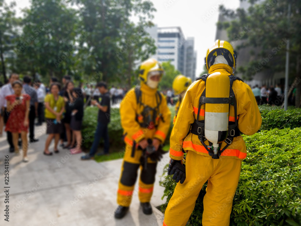 Select focus of back Firefighters in yellow suit with an oxygen tank in ...