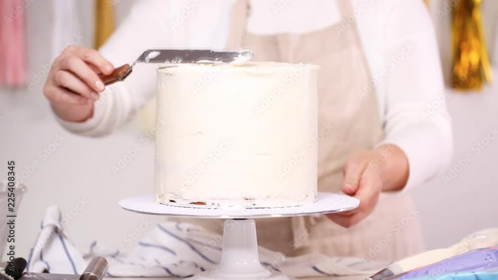 Step by step. Pastry chef stacking cake layers with buttercream ...