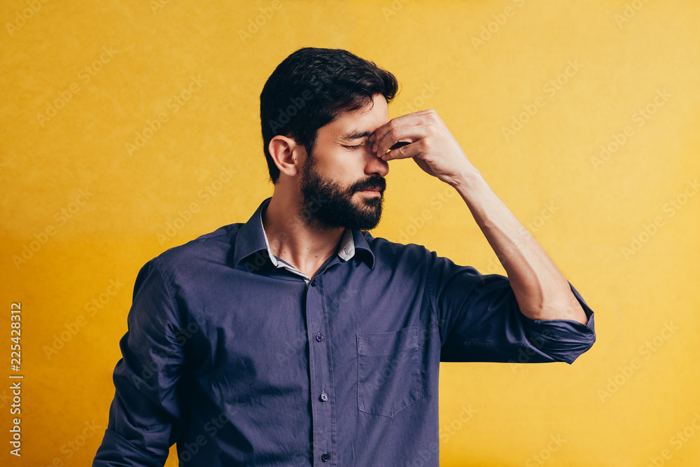 Sad man holding his nose because sinus pain Stock Photo | Adobe Stock