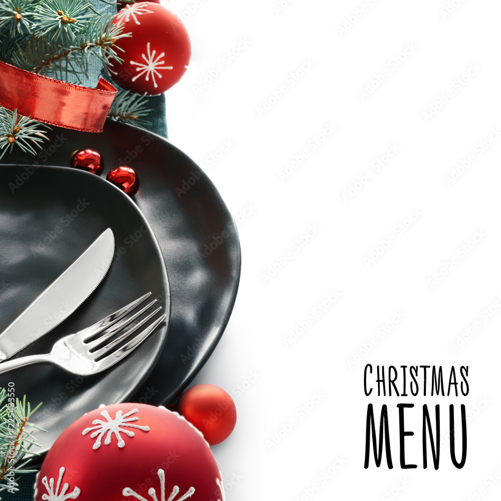 Christmas menu concept with black plates and cutlery decorated with ...