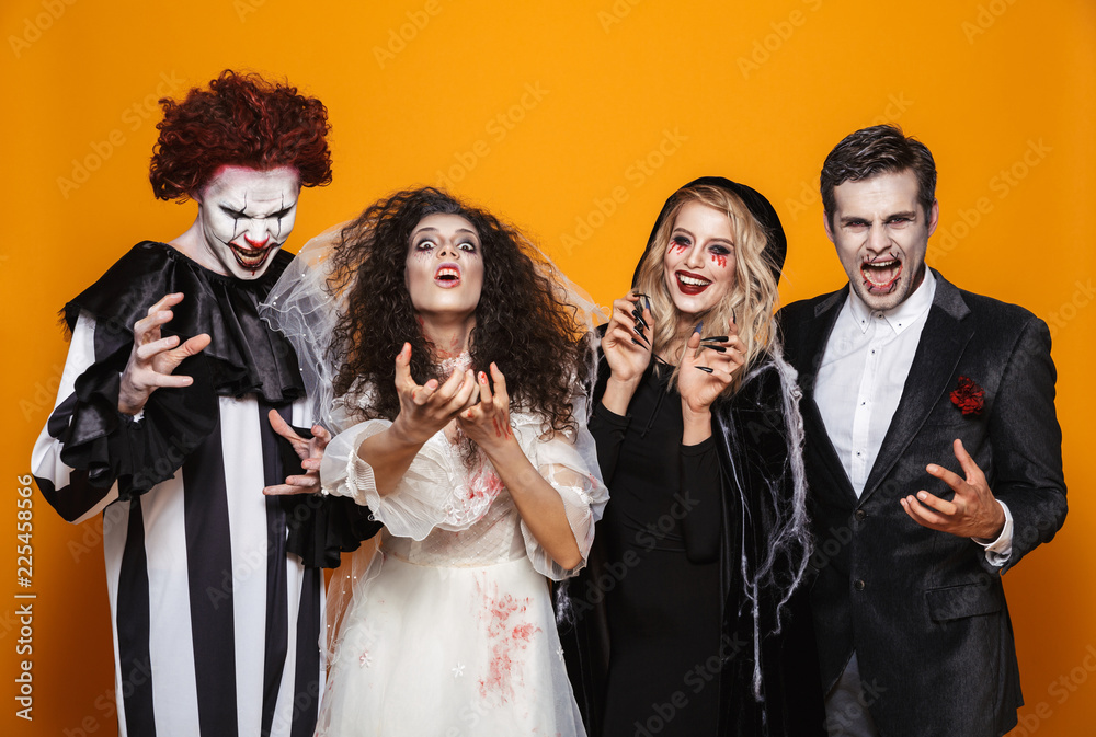 Group of smiling friends dressed in scary costumes Stock Photo | Adobe ...