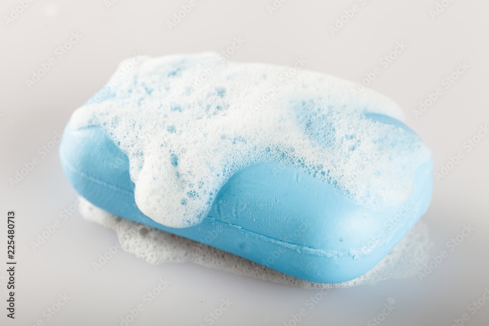 Blue Bar of Soap with Foam on the Grey Background Stock Photo | Adobe Stock