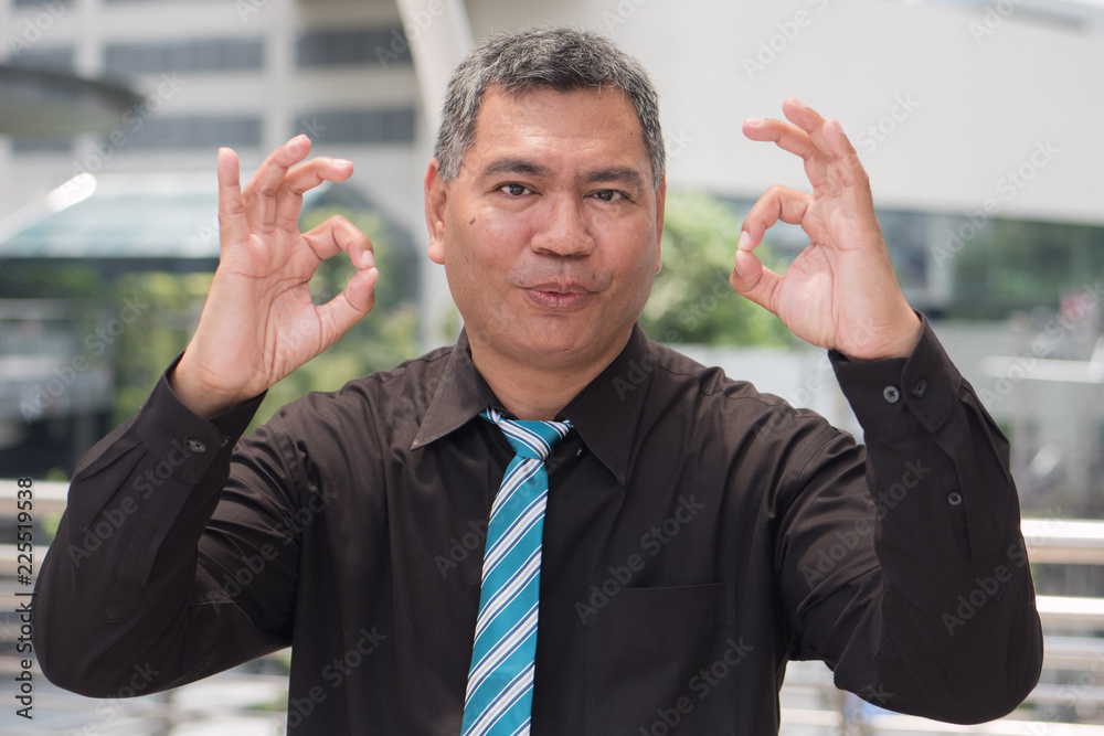 ok hand sign from successful old business man; portrait of happy ...