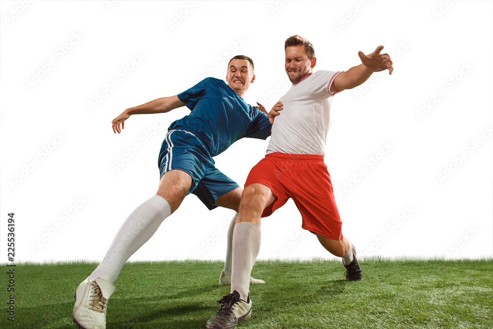 Football players tackling for the ball over white background ...