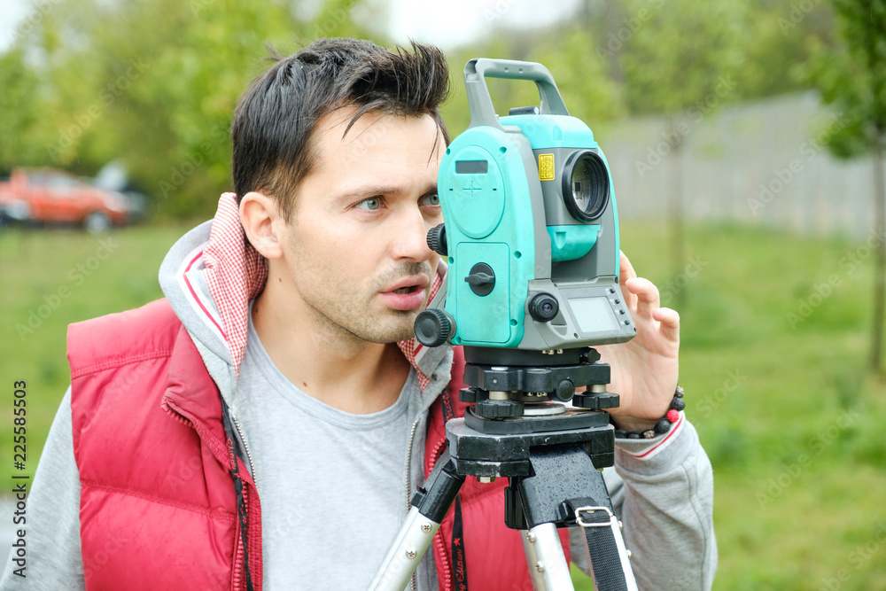 Civil engineer land survey with tacheometer or theodolite equipment ...