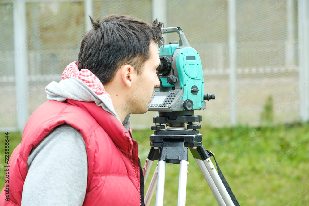 Civil engineer land survey with tacheometer or theodolite equipment ...