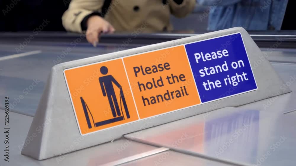 London Underground Escalator. Please hold the hand rail. Please stand ...