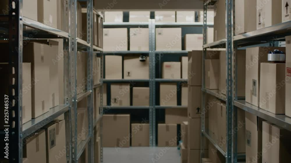 Zooming In Moving Shot Inside Warehouse Storeroom with Rows of Shelves ...