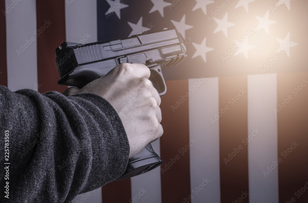 Woman's hand holding gun on flag of USA background. Gun Violence in the ...