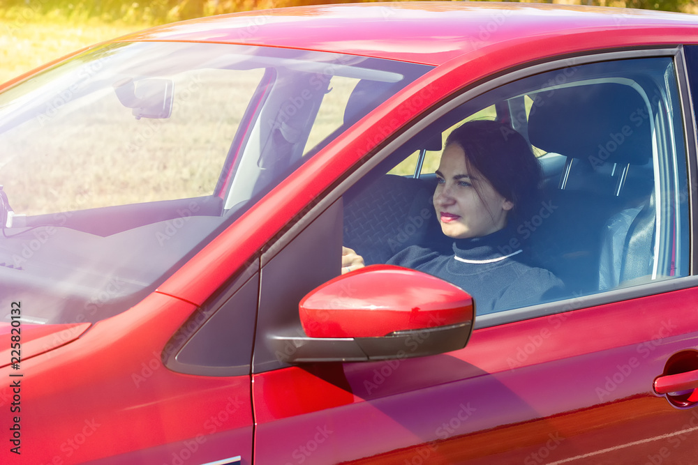 Young, beautiful, happy woman driving a red car. Woman driving ...