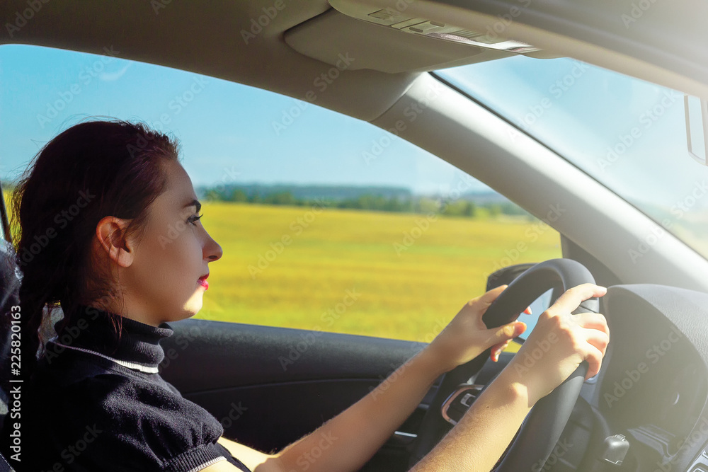 Woman driving. Beautiful young business lady drives a car. The concept ...