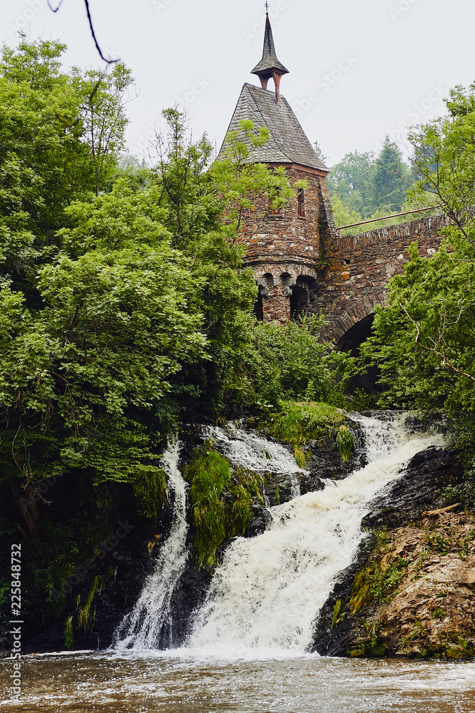 Medieval tower, bridge and waterfall Stock Photo | Adobe Stock