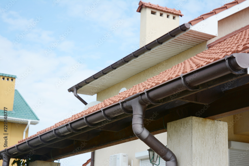 Guttering. Roof gutter pipeline sysem. House rain gutter with holders ...