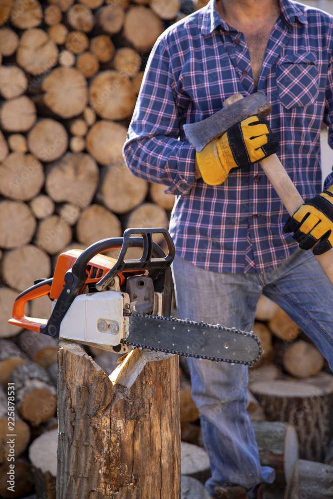 The worker works with a chainsaw. Chainsaw close up. Woodcutter saws ...