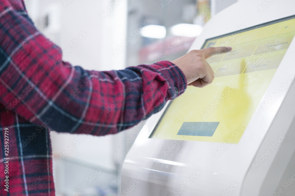close up person using touch screen panel in post office to recieve a ...