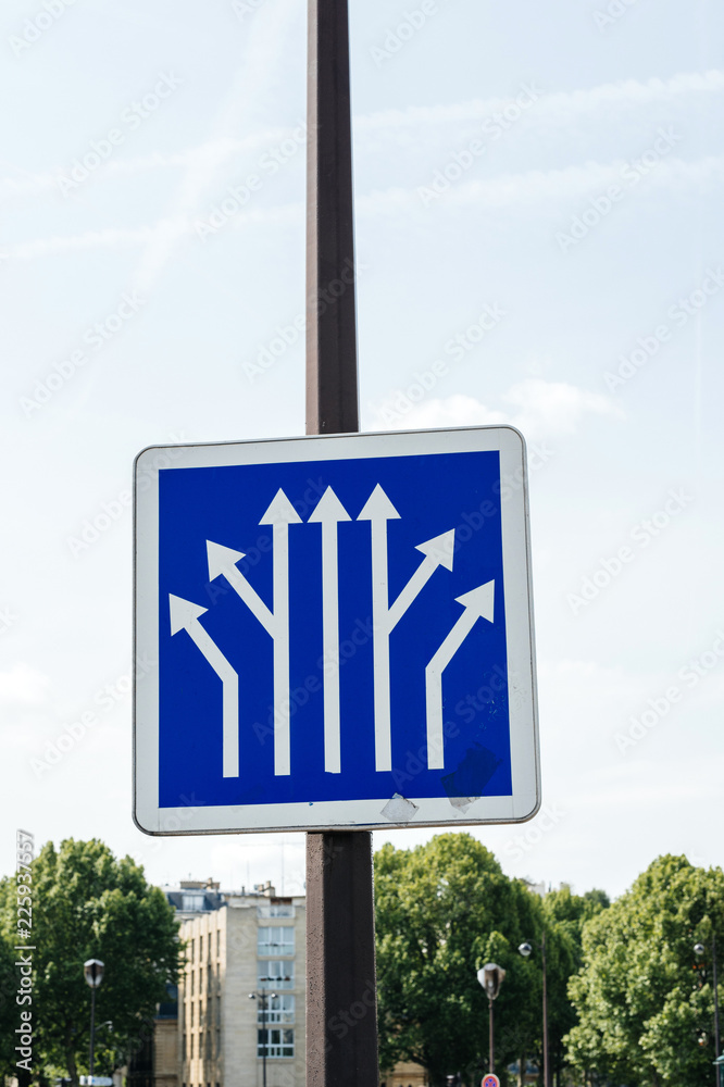 Blue informational traffic sign post over a clear blue sky showing ...