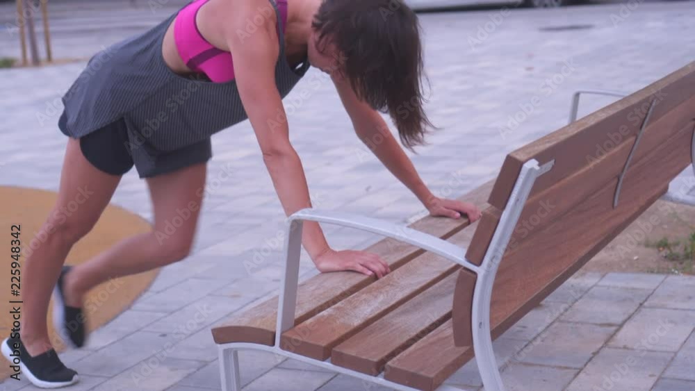Athlete woman doing push-ups on bench Stock Video | Adobe Stock
