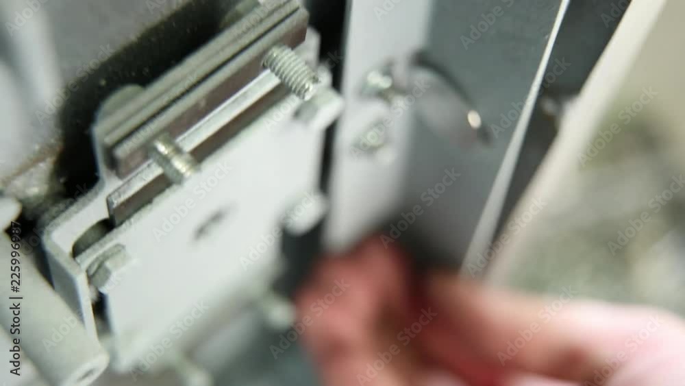 Adjustment of the locking mechanism of the safe. The worker adjusts the ...