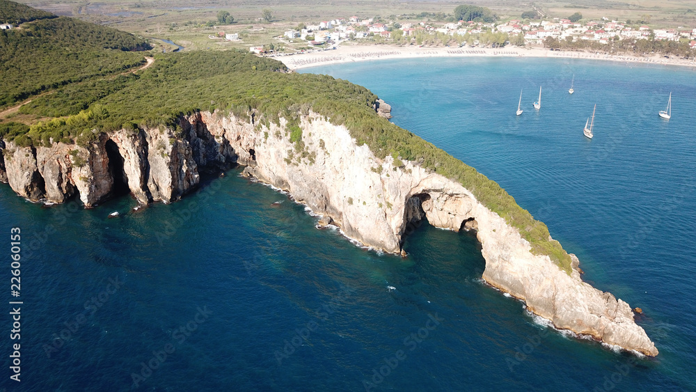 Aerial drone photo of unique beauty of caves and beach o Amoudia near ...