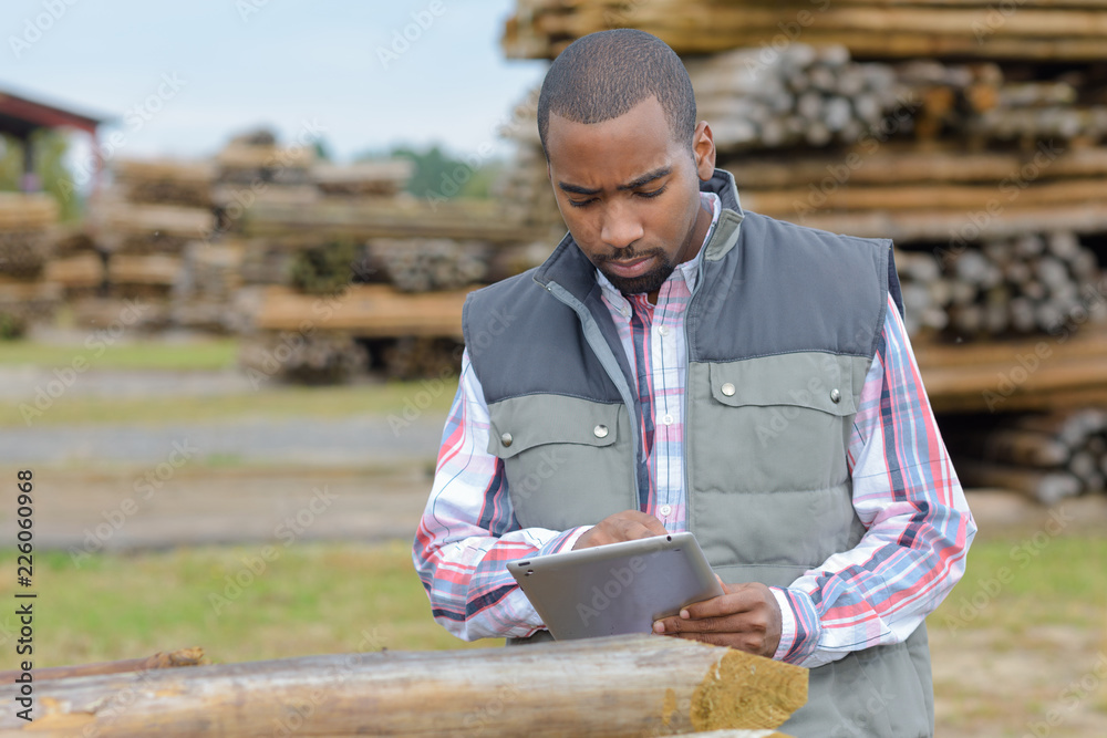 log worker holding a tab Stock Photo | Adobe Stock log worker holding a tab Stock Photo | Adobe Stock