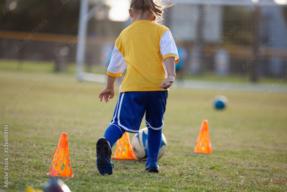 Soccer players practicing on a field. Stock Photo | Adobe Stock