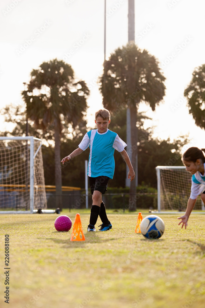 Soccer players practicing on a field. Stock Photo | Adobe Stock