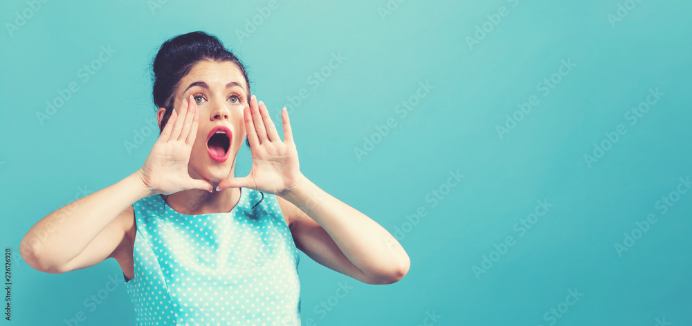 Young woman shouting on a solid background Stock Photo | Adobe Stock