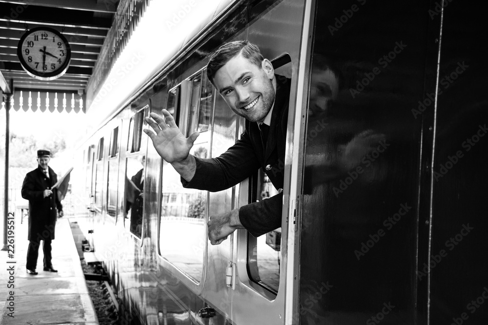 Ww2 vintage man in uniform arrives at railway station and waves with ...